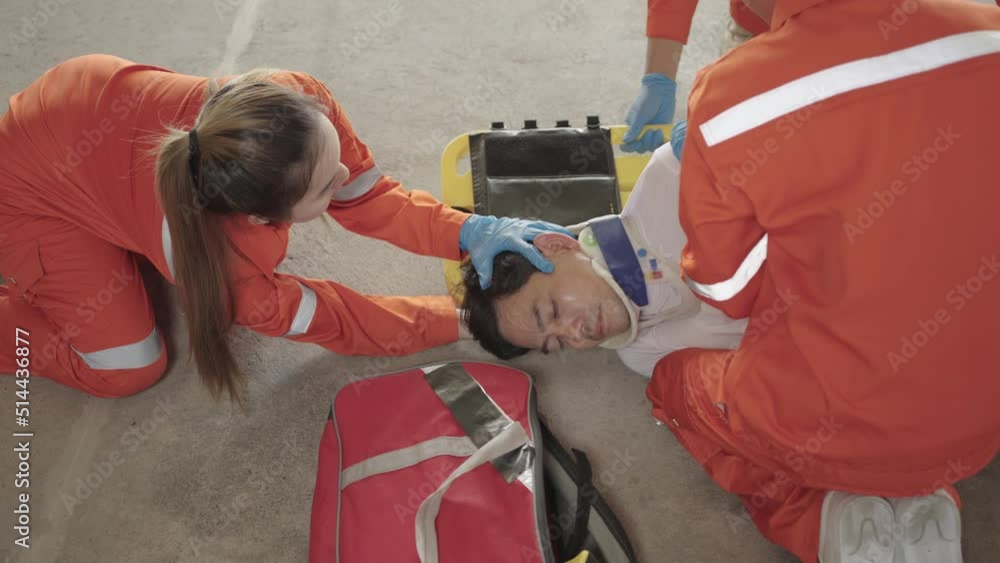 Female medical used her hands to support the accident victim's head and ...
