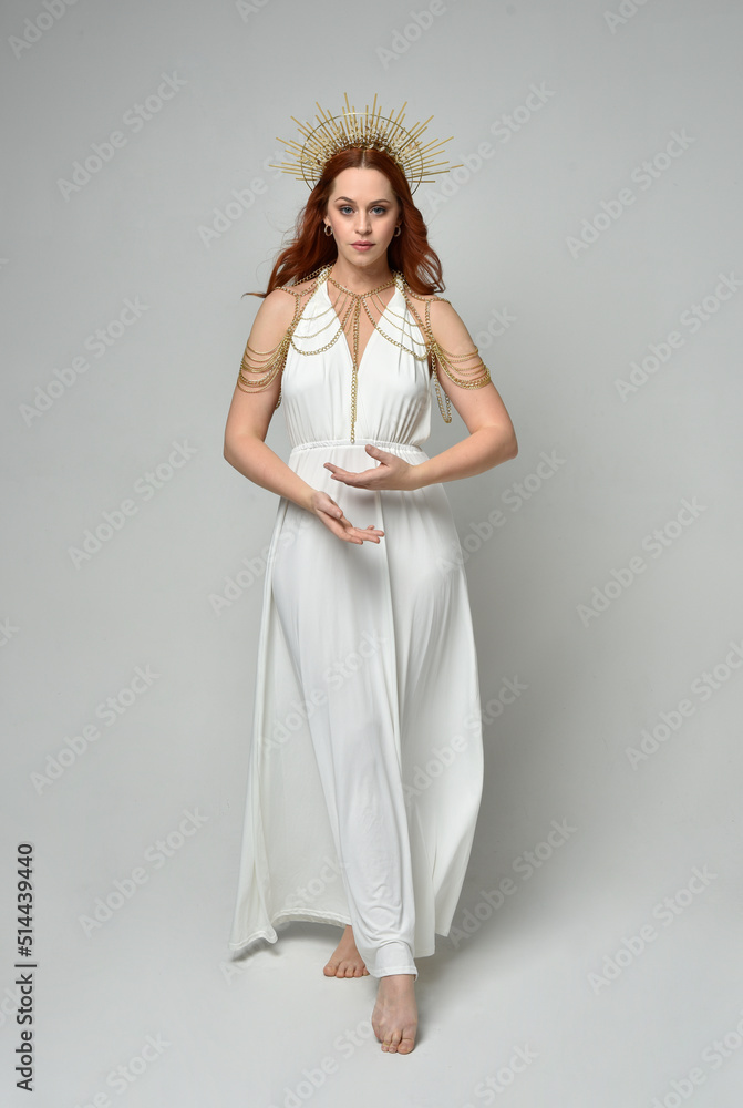 Full length portrait of beautiful red head woman wearing long flowing ...