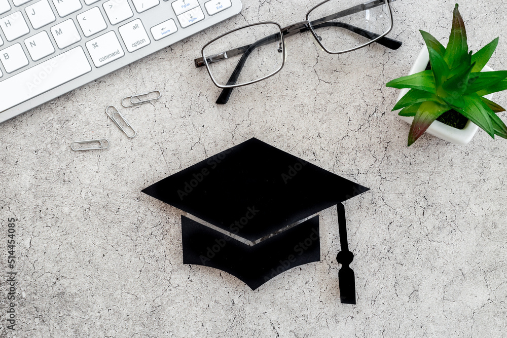 Black academic cap or graduation hat on students table, top view Stock ...