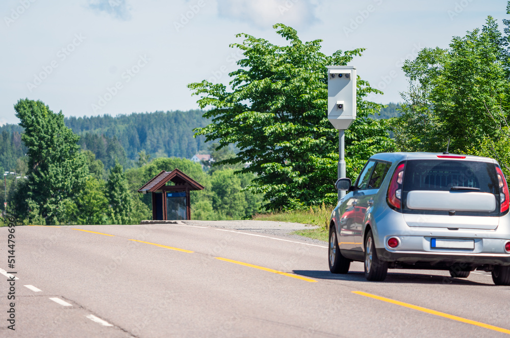 Traffic enforcement camera, with car driving by. To simulate the many ...