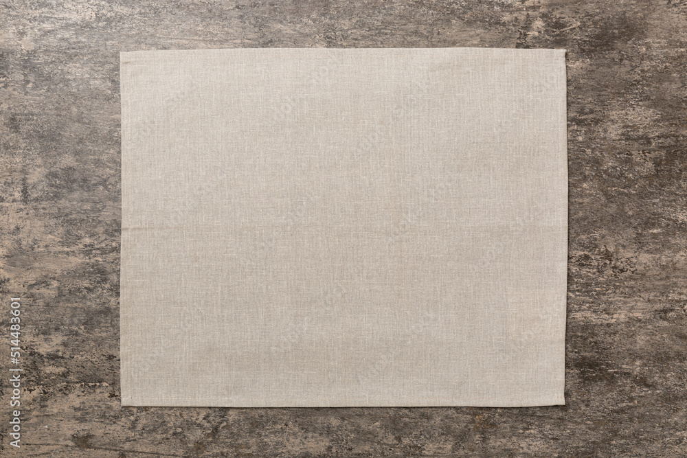 Top view of grey tablecloth for food on cement background. Empty space ...