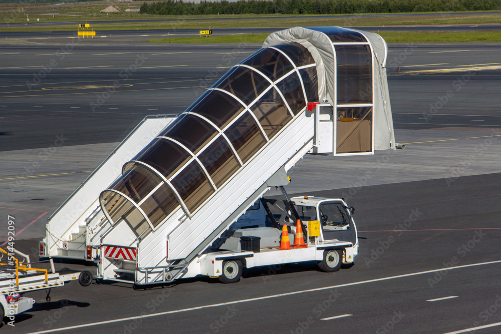Mobile stairs for boarding and alighting passengers parked at the ...