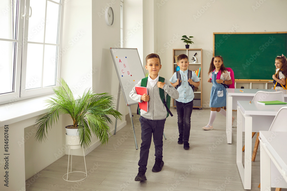 Elementary students leaving school after classes are over. Happy school ...