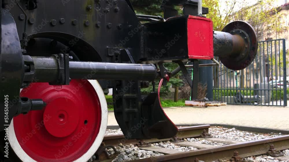Steel red wheels with a white rim of a steam locomotive on rusty metal ...