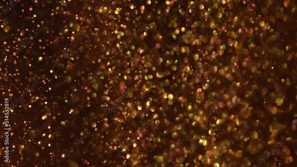 Video Stock Real gold glitter particles float in liquid. Gold dust ...