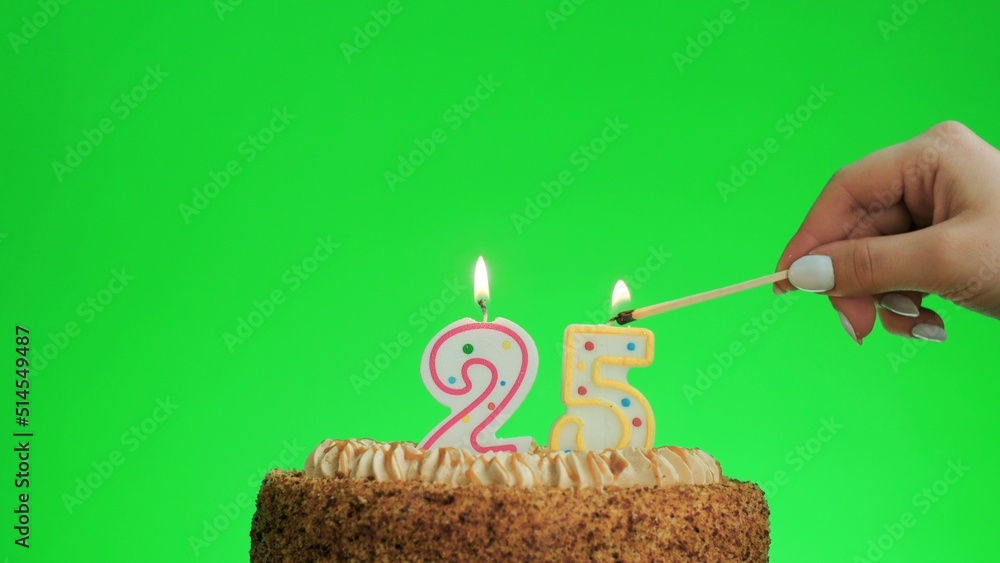 Cake with lighted candle number 25. Green screen background. Isolated ...