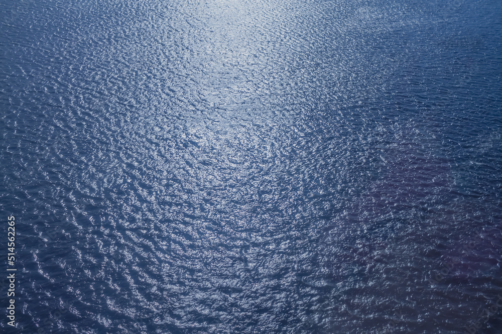 The texture of dark blue water of a river or lake with small waves and ...