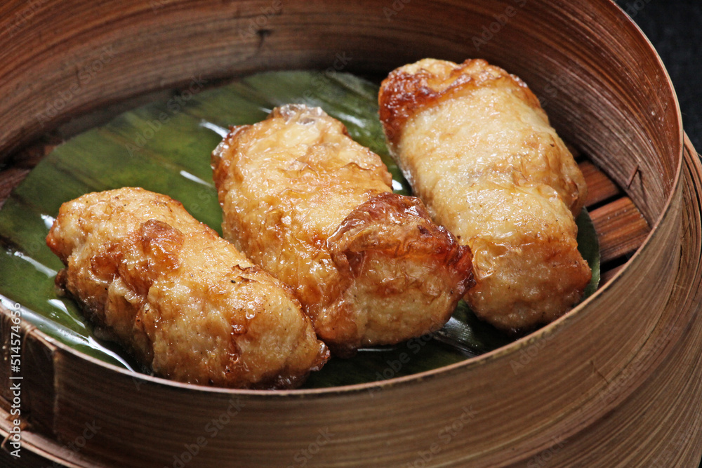Crispy fried tofu skin dim sum with prawns and chicken served in a ...