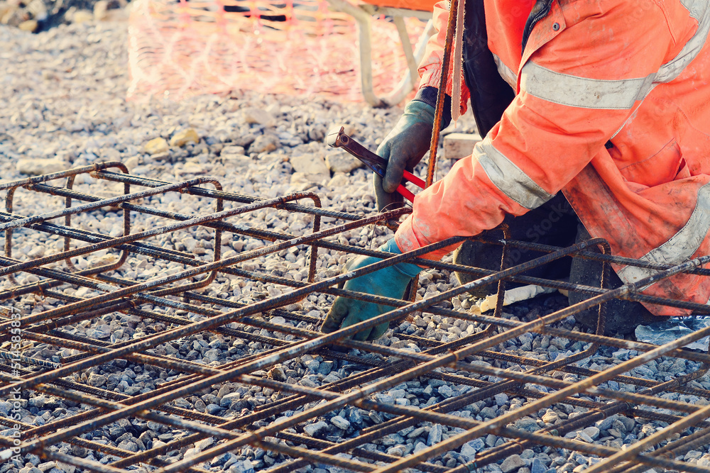 Builders Hands Fixing Steel Reinforcement Bars At Construction Site Steel Fixer Assembling