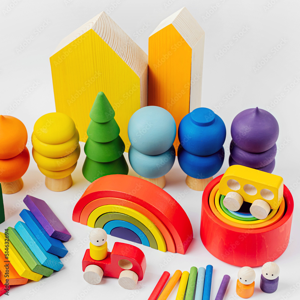Colorful wooden toys. Houses, trees, toy cars and little men in the ...