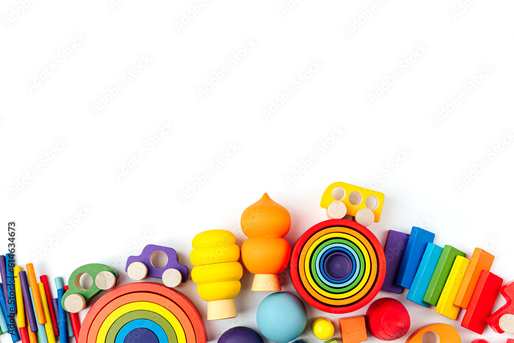 Colorful wooden toys in the colors of the rainbow on white background ...