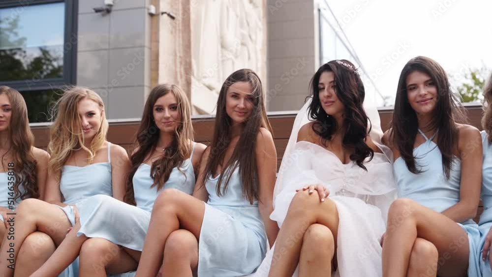 Attractive bride and bridesmaids switching crossing legs sitting on ... Attractive bride and bridesmaids switching crossing legs sitting on ...
