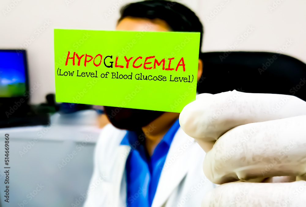Hypoglycemia, medical term. Scientist hold card with text Hypoglycemia ...