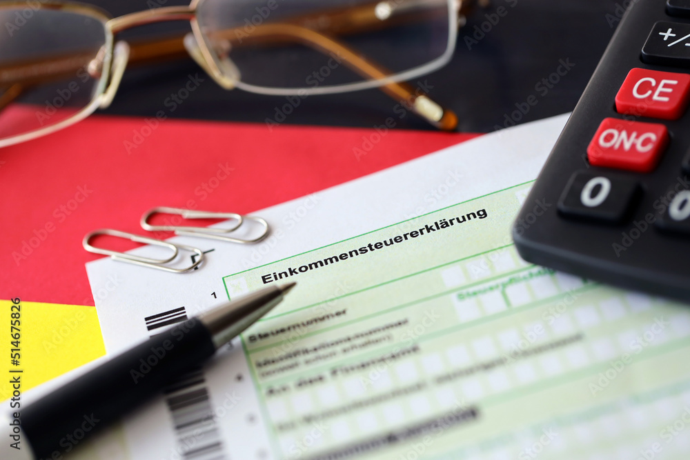 German income tax return form with pen and european euro money bills ...