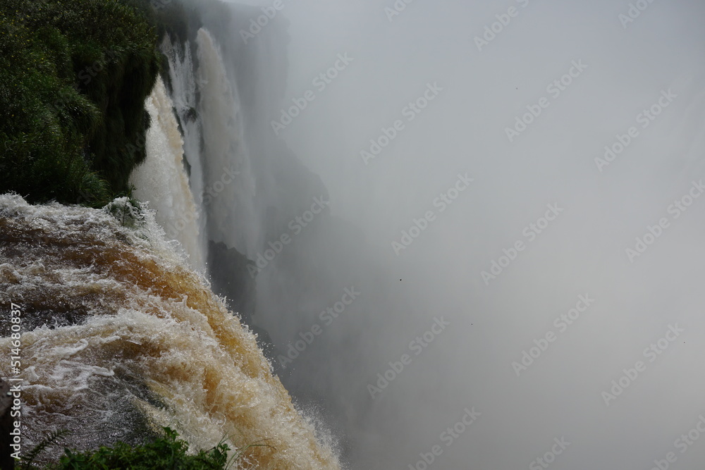 The photo shows a stunning view from the top of the Iguazu Falls — a ...