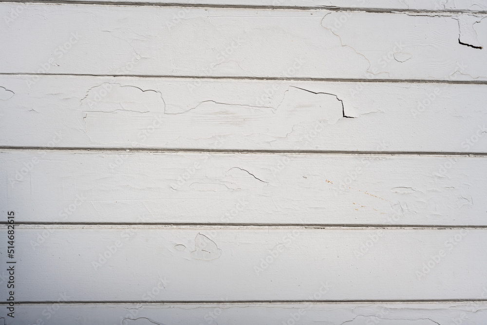 Dirty, old, blistered and flaking, repainted old white painted board ...