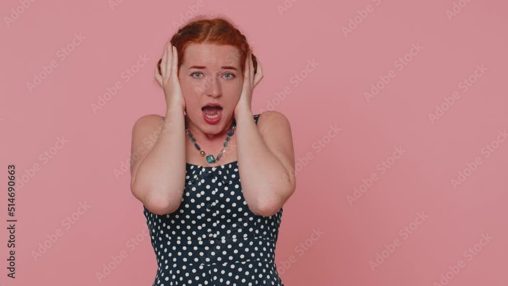 Scared fearful redhead woman covering ears with hands, closing eyes ...