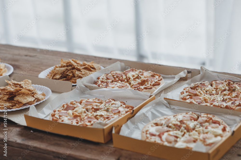 Many pizzas are placed on the table at the company, corporate office ...