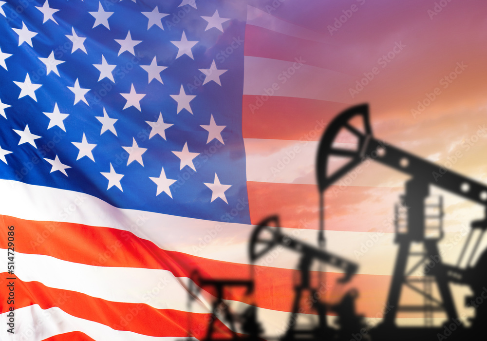 American oil fields. Oil pump in front of American flag. Oil production ...
