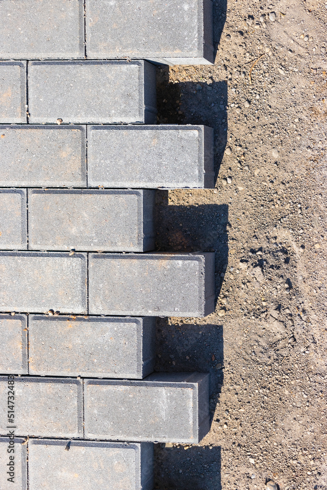 Pavement repairs and paving slabs laying on the prepared surface, with ...