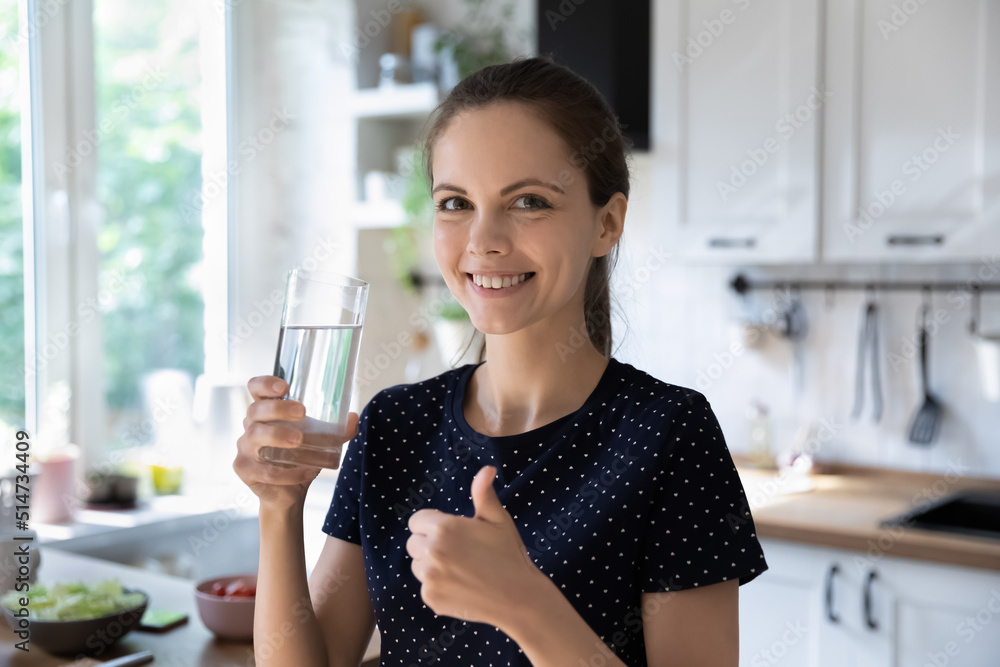 Happy pretty young woman satisfied with pure fresh water quality ...