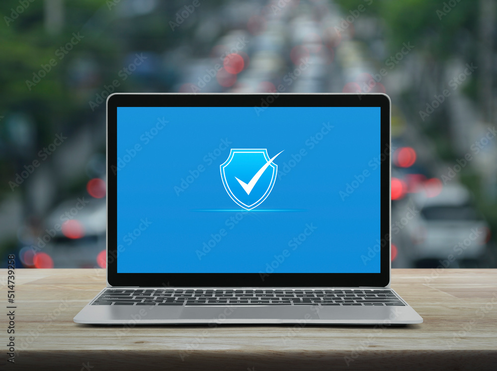 Security shield with check mark icon on modern laptop computer monitor ...
