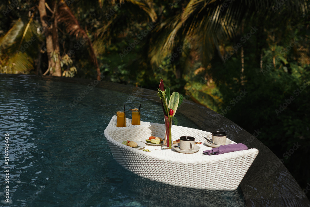 Breakfast in swimming pool, floating breakfast set in tray in resort ...