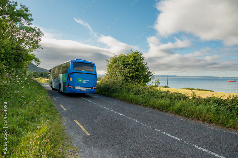 Foto Stock Burren, Ireland - 06.22.2022: Blue passenger bus with TFI ...