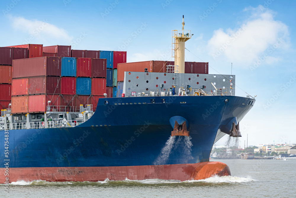 A large cargo ship, carrying a large number of containers floating in ...