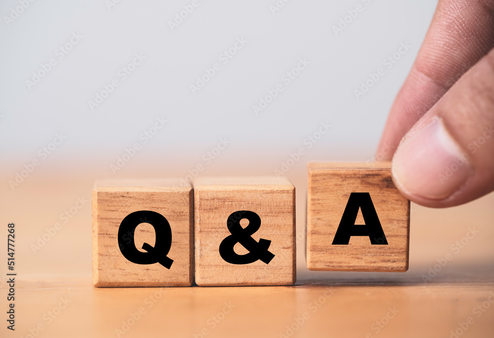 Hand putting QA which print screen on wooden cube block for Question ...