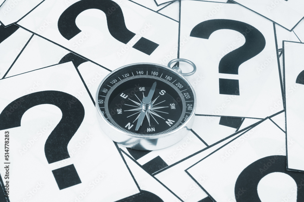 Travel questions and business navigation concept. Round compass on ...