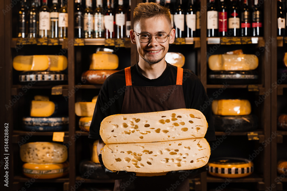 Handsome cheese sommelier with 2 half of yellow cheese wheel limited ...