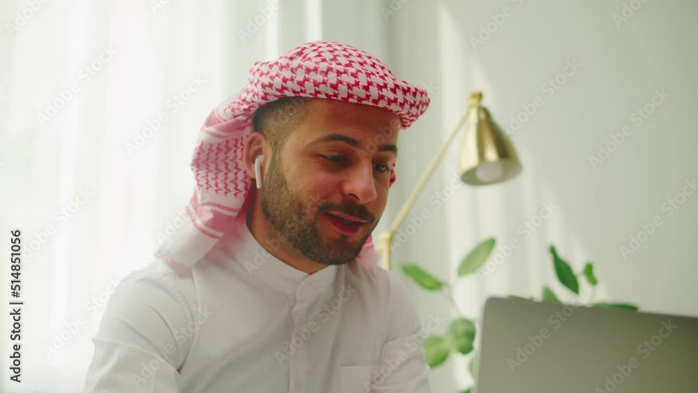 Middle eastern man calling on virtual conference, using earphones. Male ...