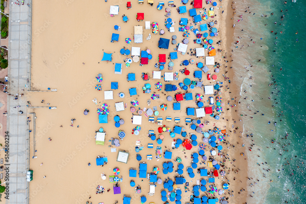 Aerial view top down of a large crowd of beach patrons on the beach in ...