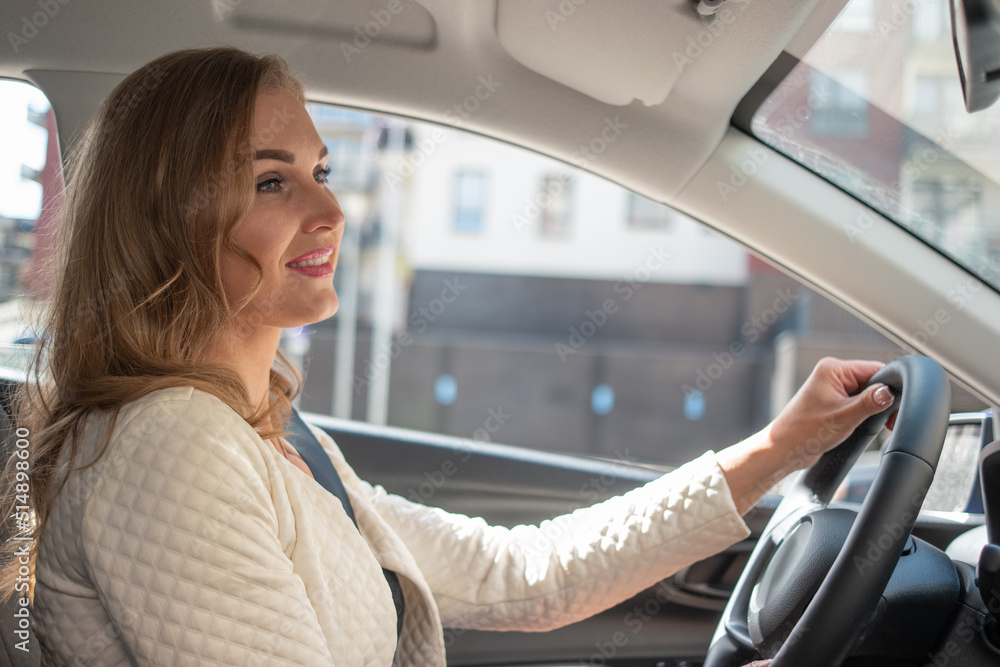 Woman driving her car Stock Photo | Adobe Stock