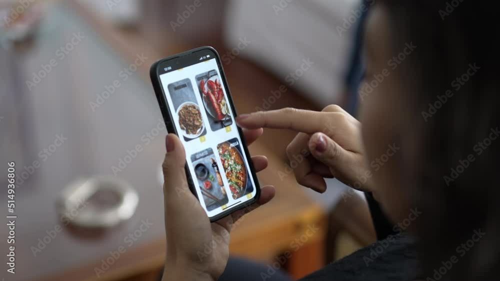 Closeup hands browsing online food app menu searching what to eat ...