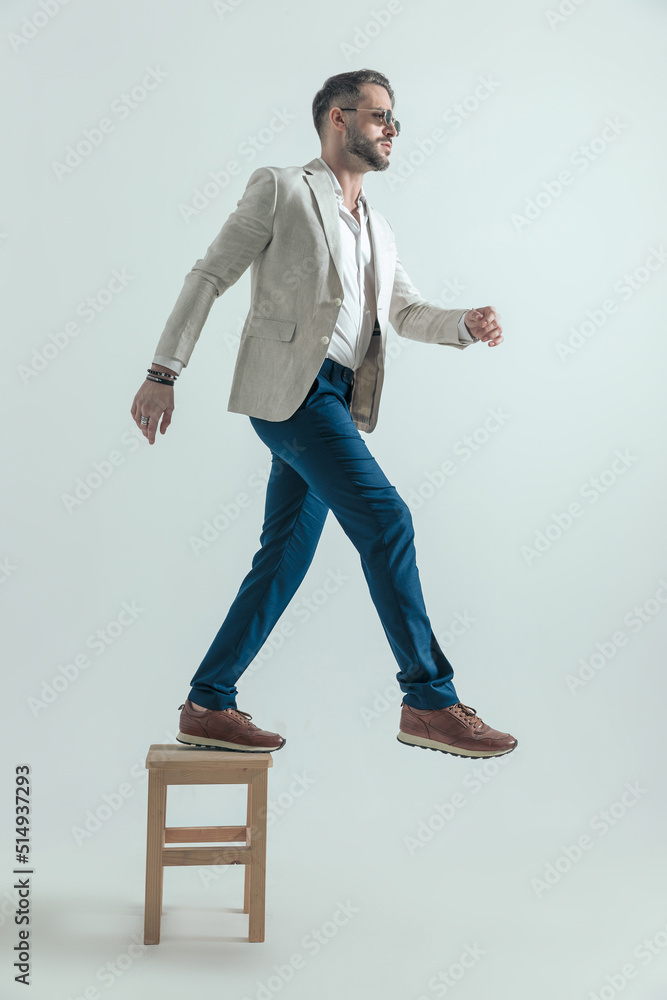 sexy businessman stepping off wooden chair into a new life Stock Photo ...