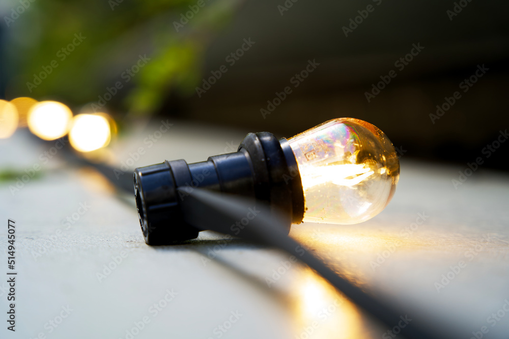 Lamp cord with LED lamps with warm white light. Party lights lying on ...