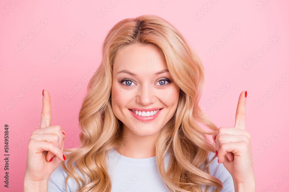 Photo of confident cheerful lady dressed blue shirt smiling pointing up ...