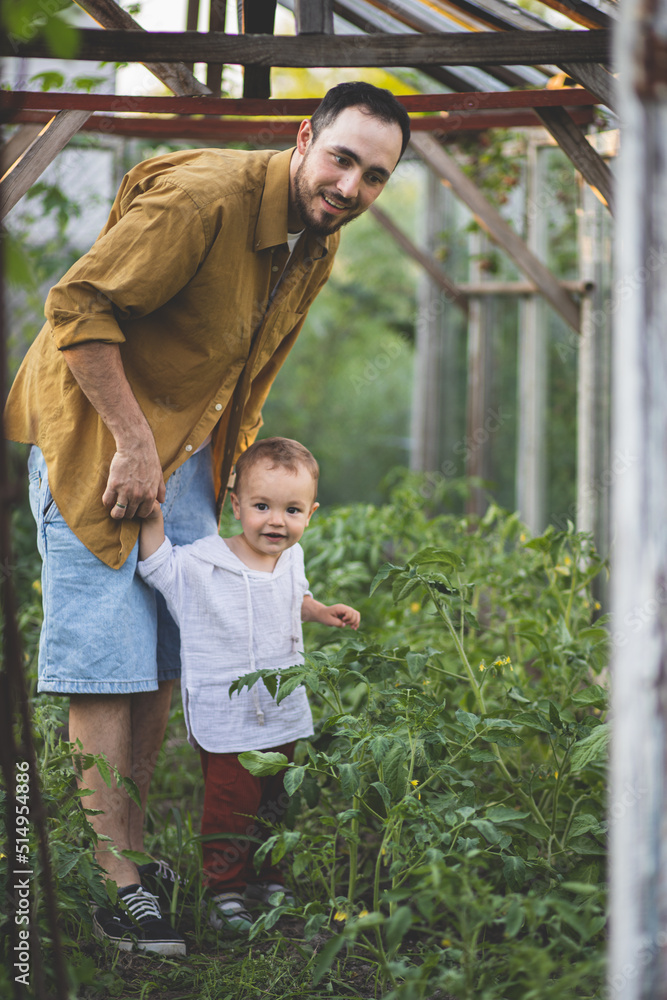 A father spends time with his son. Father and son holding hands. Happy ...