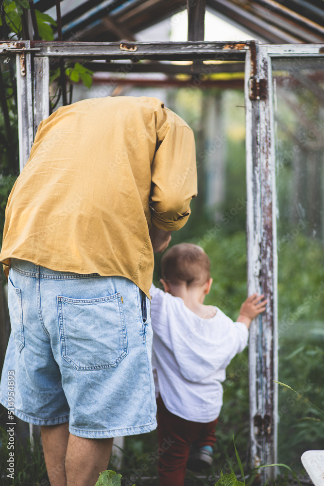 A father spends time with his son. Father and son holding hands. Happy ...