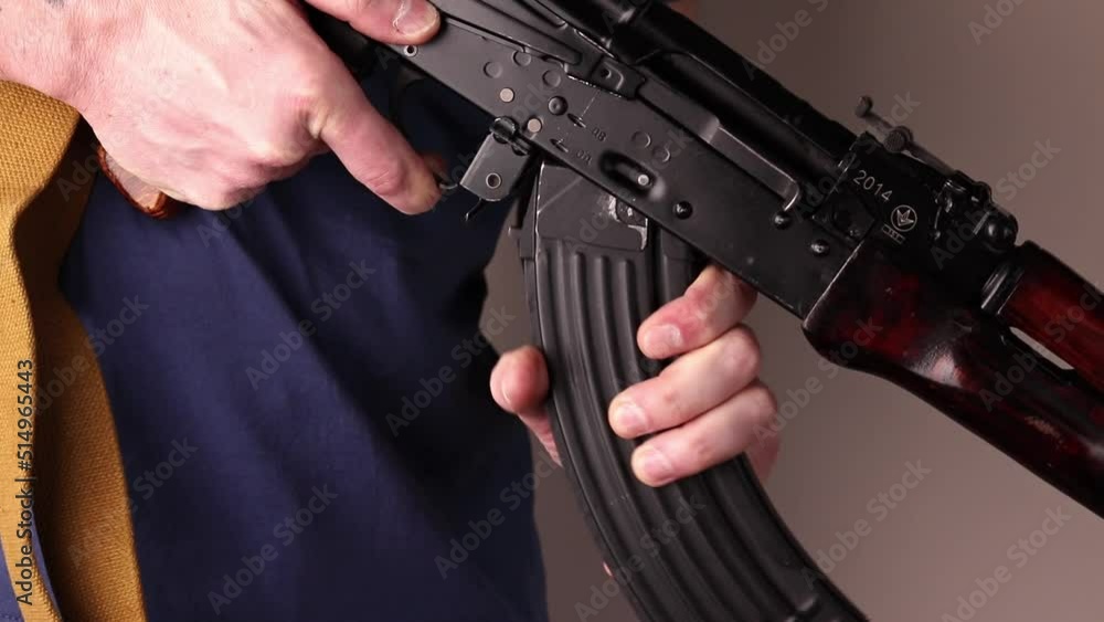 Man detaches ak-47 magazine with cartridges and unloads Kalashnikov ...