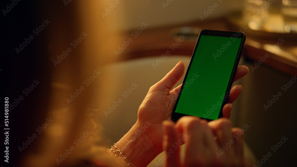 User scrolling chroma key smartphone closeup. Woman hand holding ...