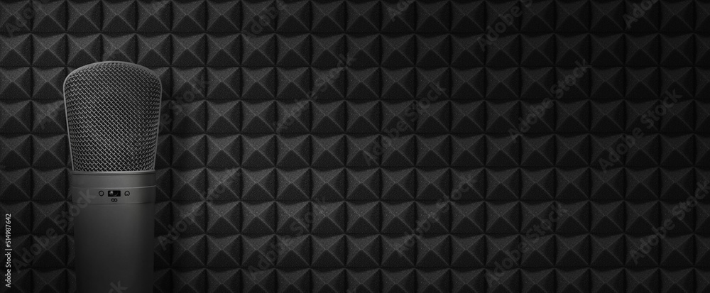 Studio microphone on dark acoustic foam background. Podcast or ...
