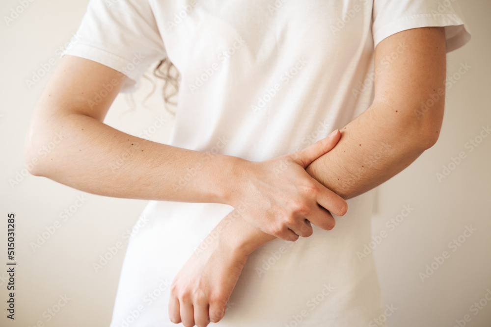 Hand injury. Beautiful girl with pain and bruise in her arm due to an ...