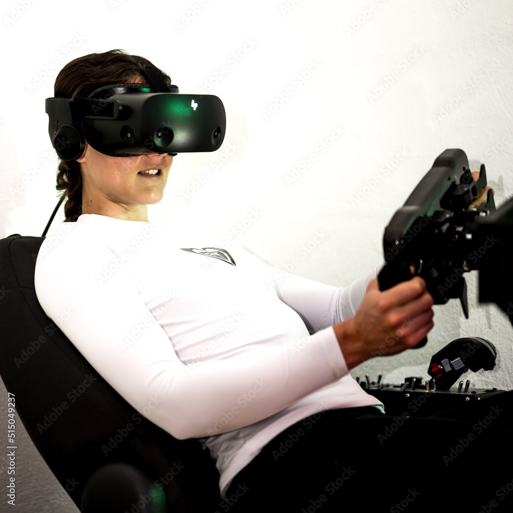 A gamer woman is sim racing with a high end simracing reck Stock Photo ...