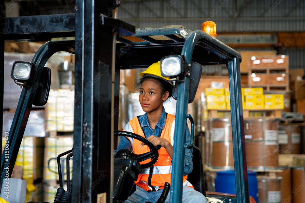 folklift operator wearing hard hat and hi visiblevest in storage ...