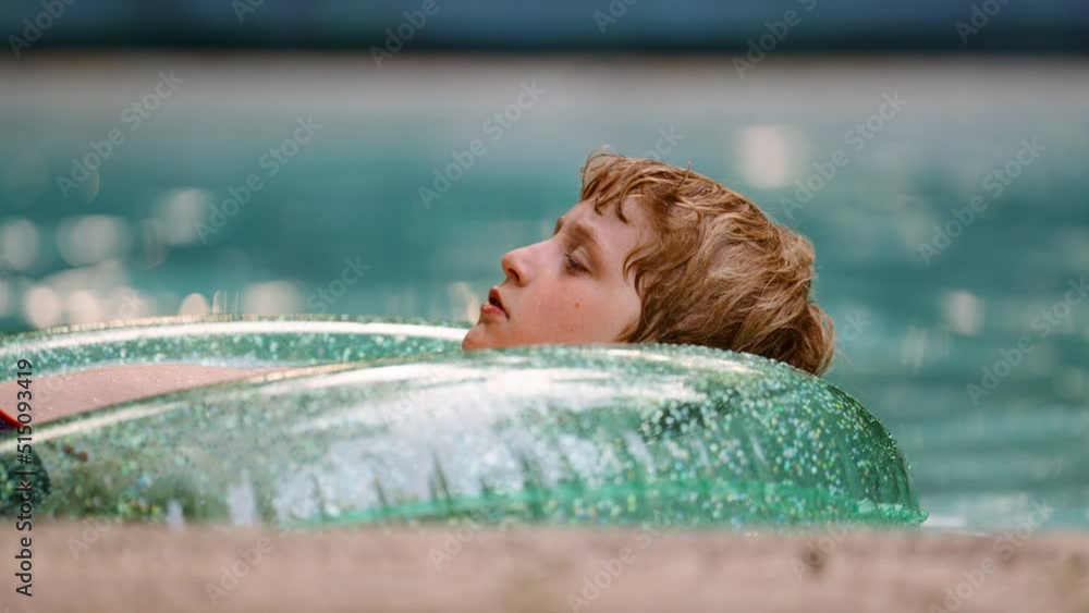 Boy Laying on an Inflatable Circle and Floating in the Pool on Summer ...