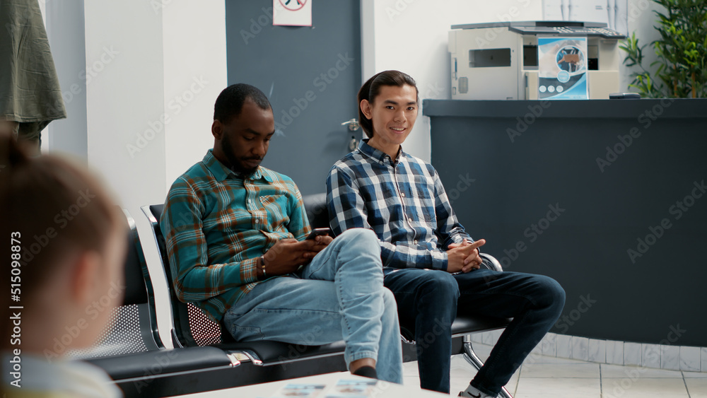 Portrait of asian patient sitting with people in waiting area lobby ...