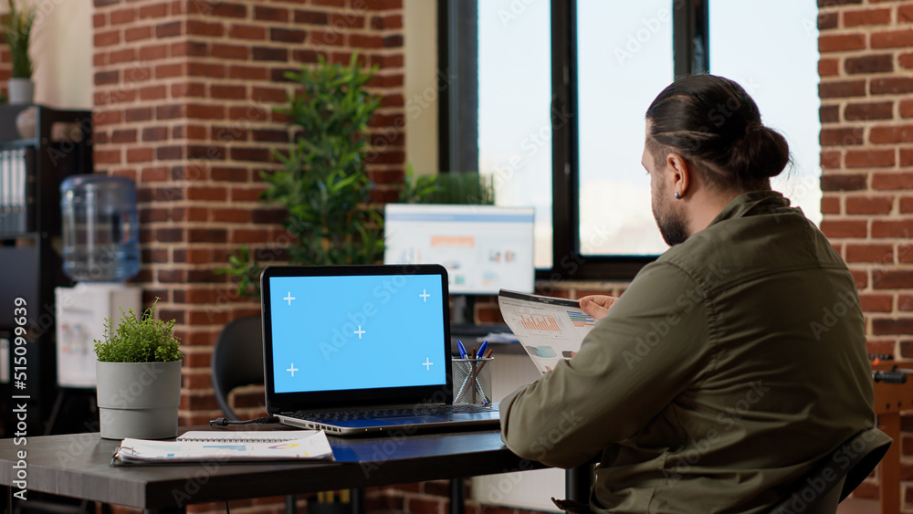 Office worker using laptop with greenscreen display at job, working ...